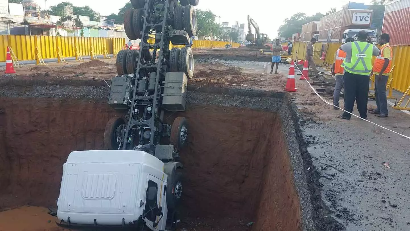 The truck plunged headlong into a giant ditch dug for a flyover near ...