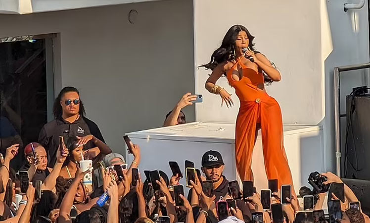 Cardi B hurls a microphone at a fan who threw a drink at her mid ...