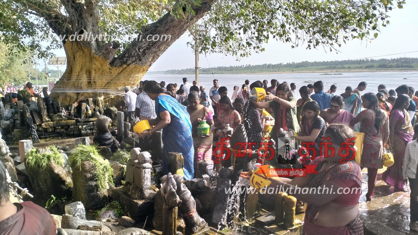 Devotees take a holy dip in Kodumudi Kaveri river on the occasion of ...