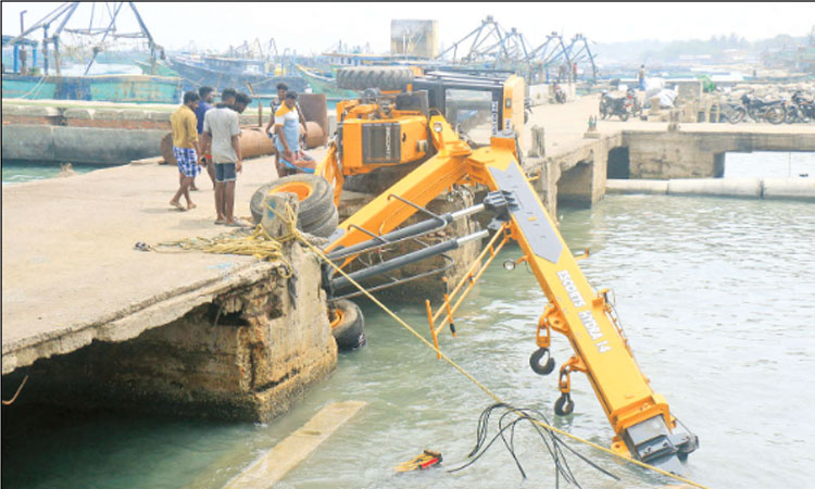 A crane for the construction of a fishing port in Rameswaram fell into ...